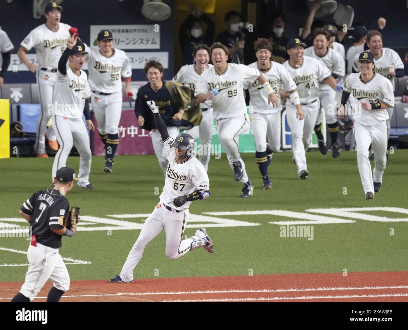 Orix Buffaloes players celebrate after Keita Nakagawa (67) hit a walk-off single in the ninth ...