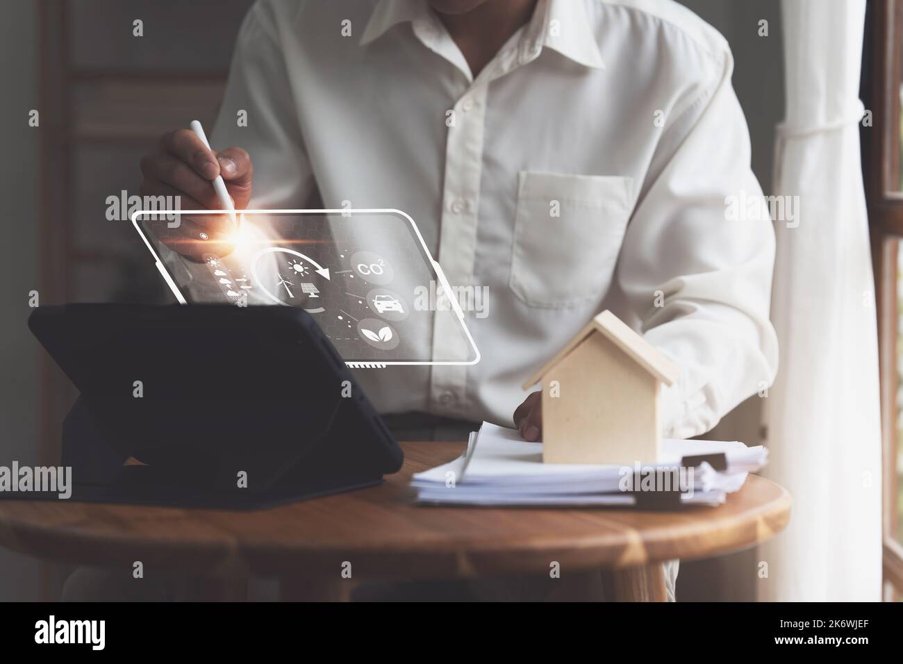 Real Estate Agent showing a energy project for future house. Green ...