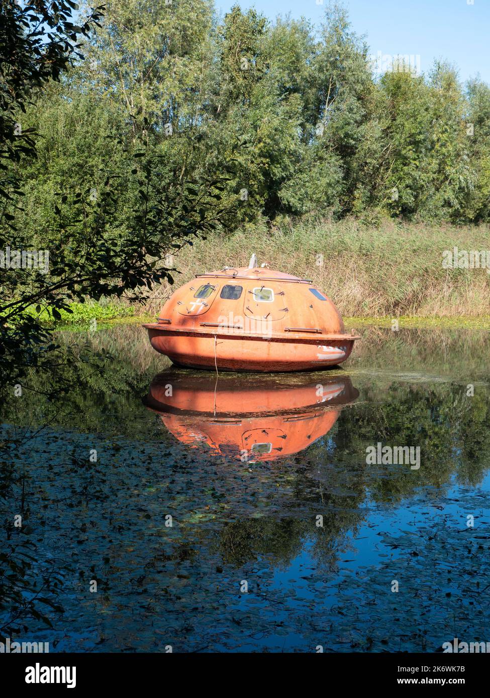 Vertical photo of an orange rescue pod or fully lockable lifeboat on ...