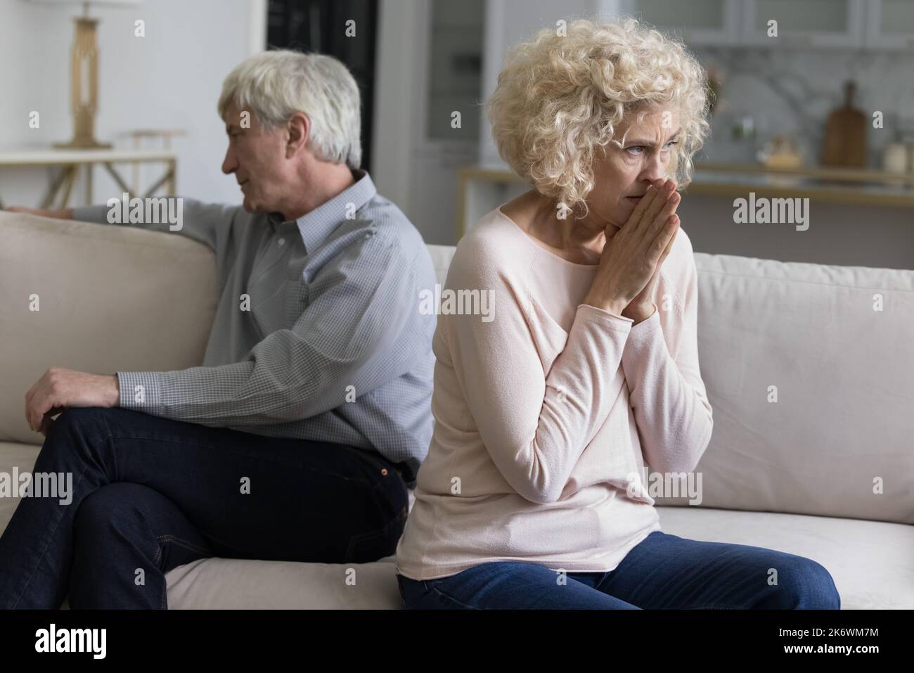 Older couple sit apart in couch feel dissatisfied with relations Stock ...