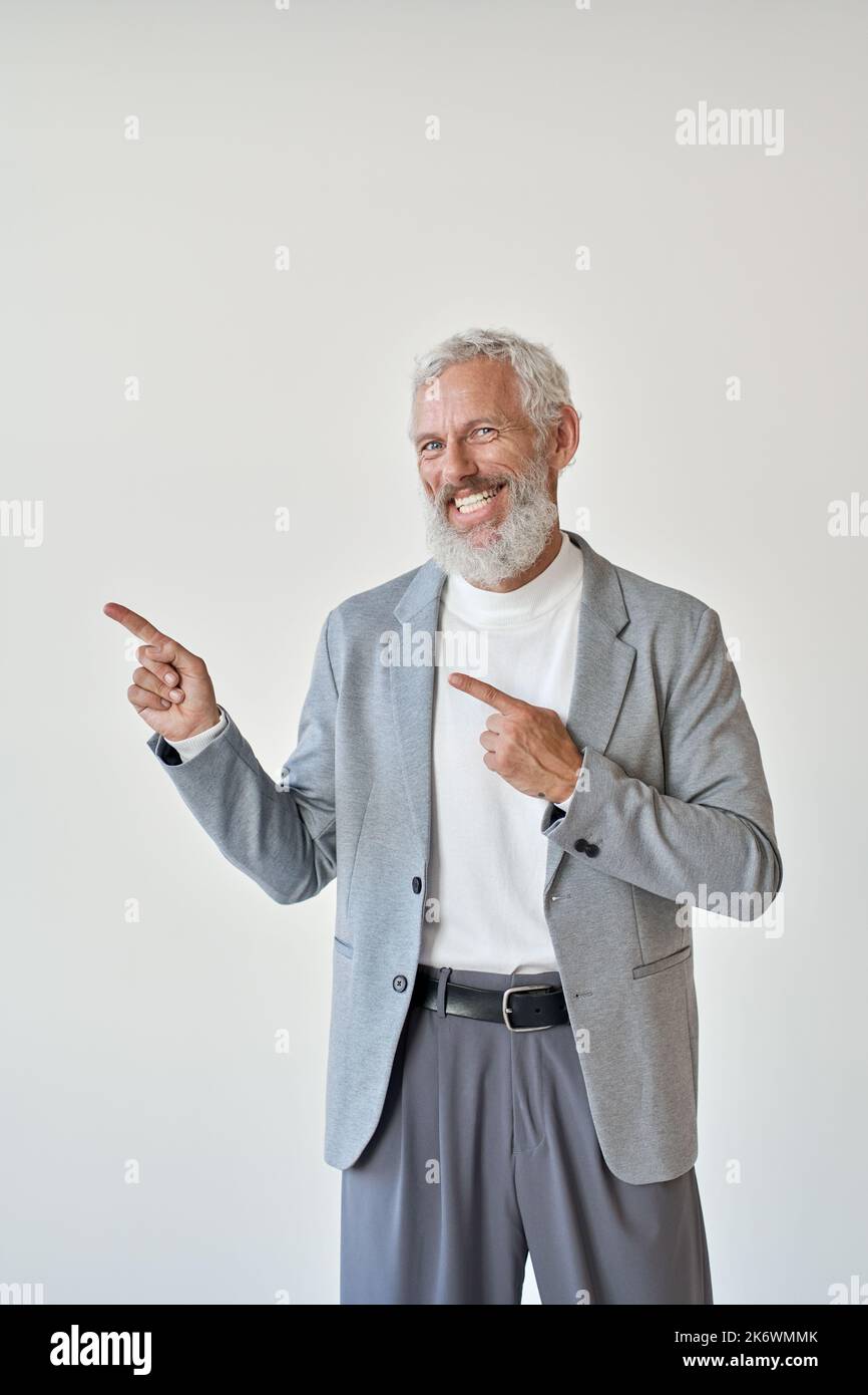 Happy old senior business man pointing fingers advertising isolated on ...
