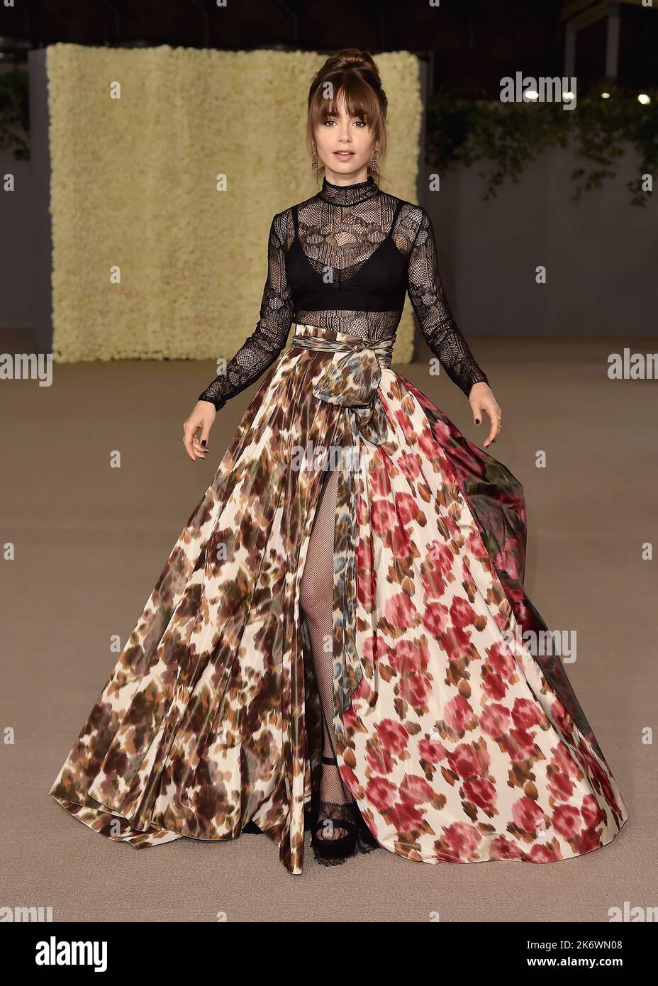 Lily Collins walking the red carpet at the Second Annual Academy Museum ...