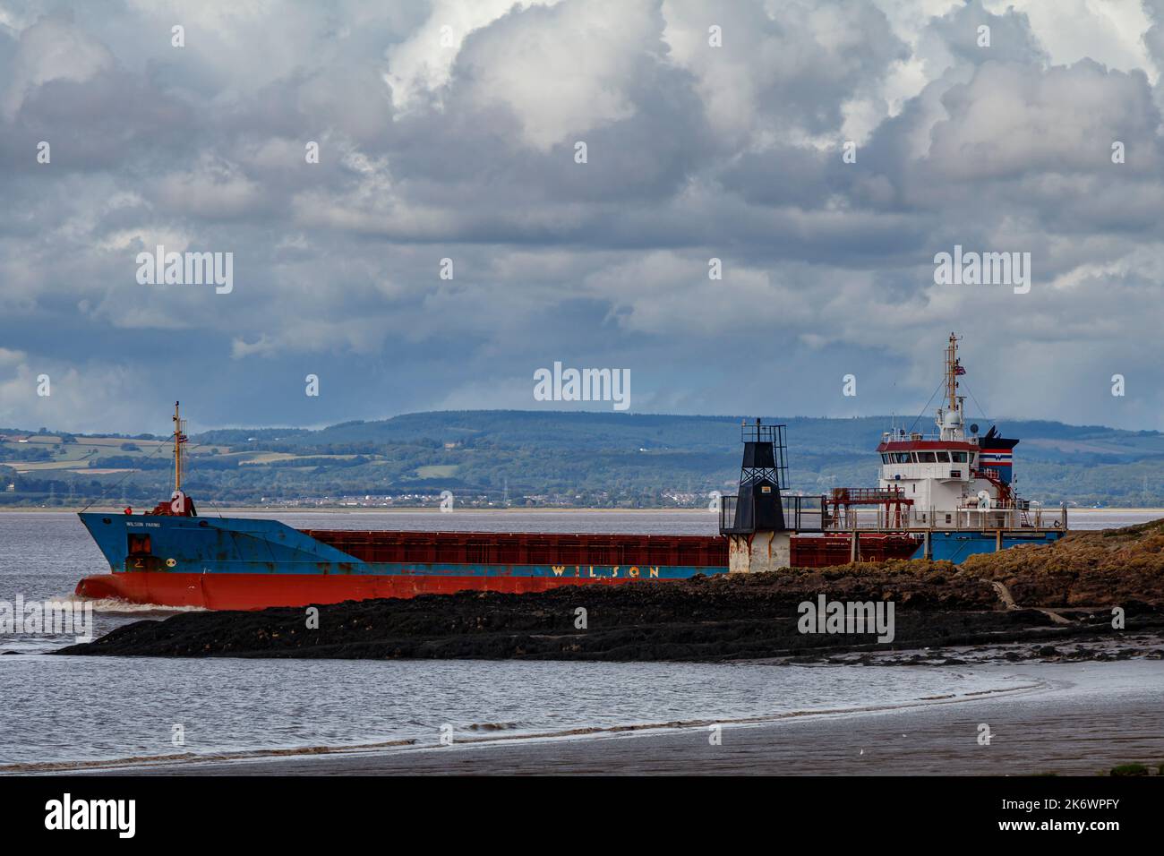 Coastal cargo vessel heading out to sea Stock Photo - Alamy