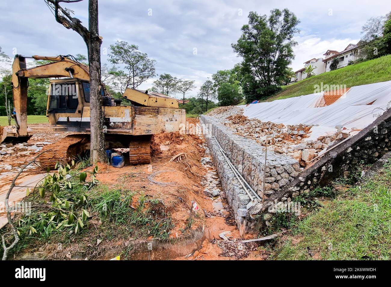 Series of slope retention construction design with rocks and mesh to ...
