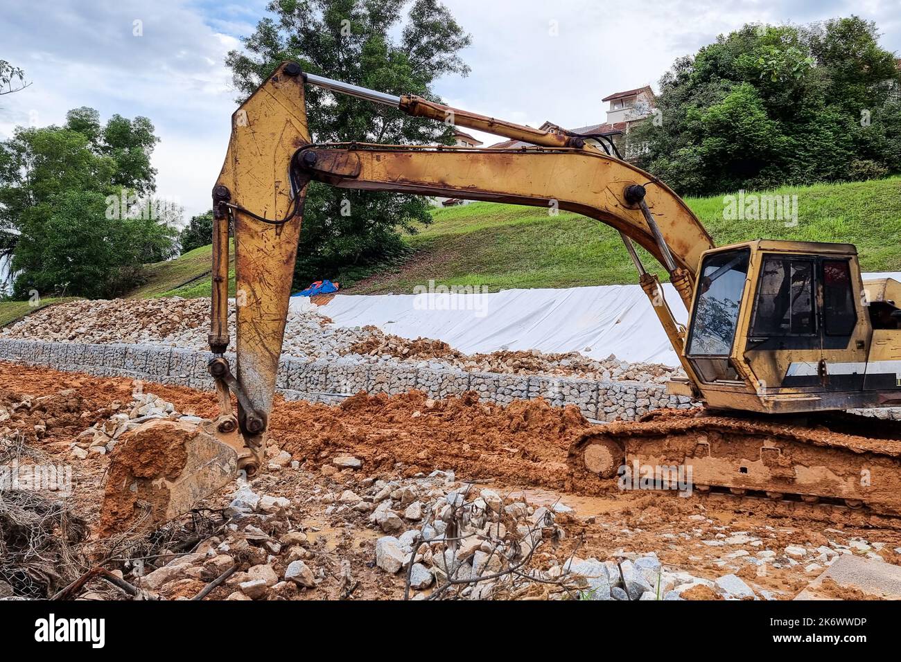 Series of slope retention construction design with rocks and mesh to ...