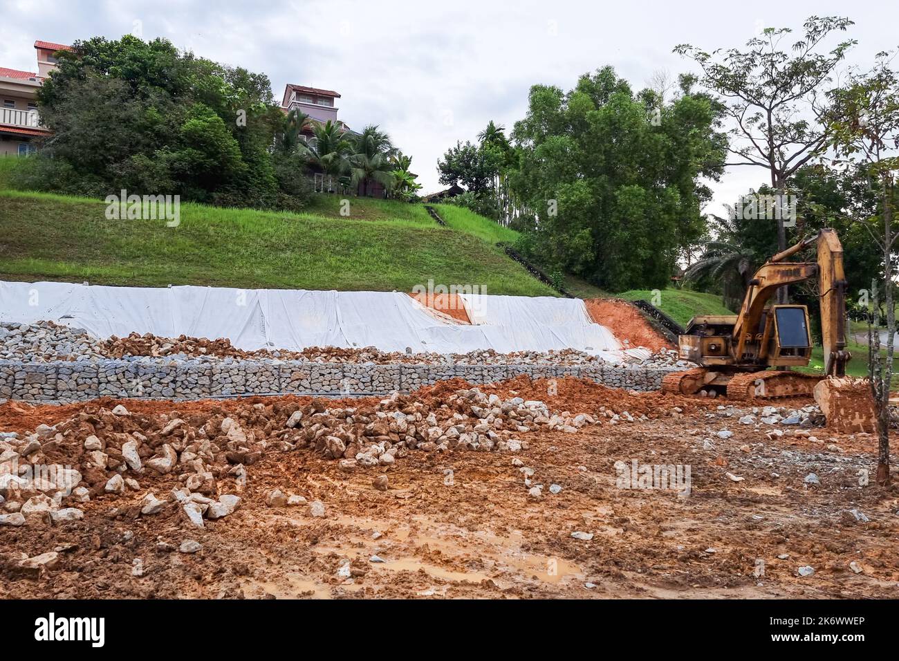 Series of slope retention construction design with rocks and mesh to ...