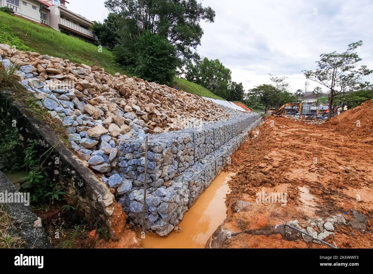Series of slope retention construction design with rocks and mesh to ...