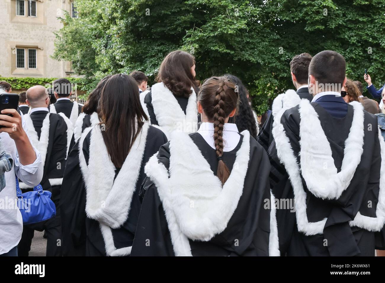 29 6 2022 back view of Male and female fresh graduate students with ...