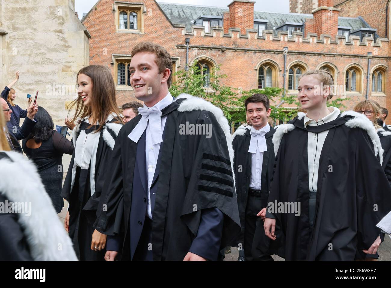 29 6 2022 back view of Male and female fresh graduate students with ...