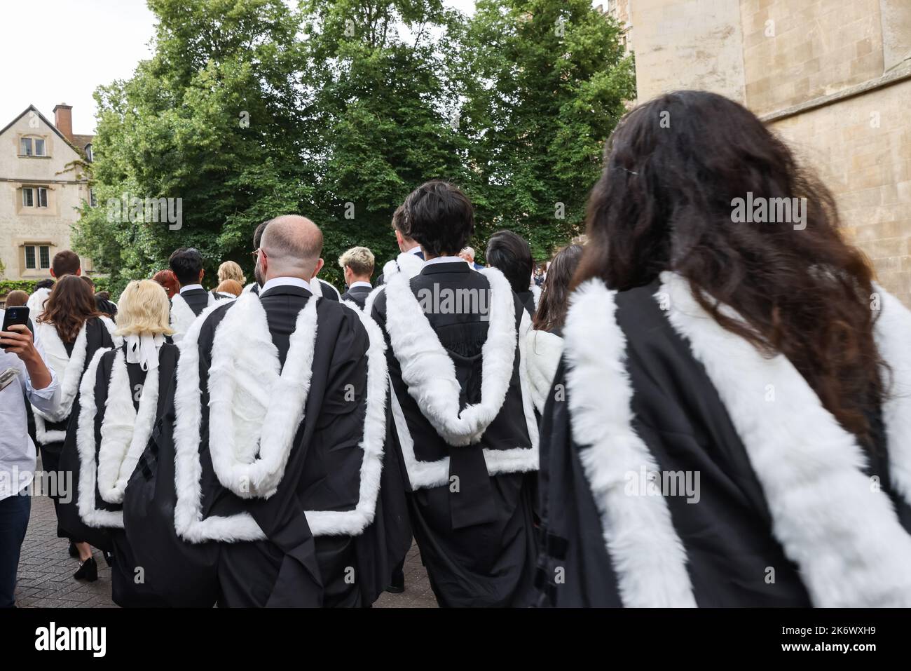 29 6 2022 back view of Male and female fresh graduate students with ...