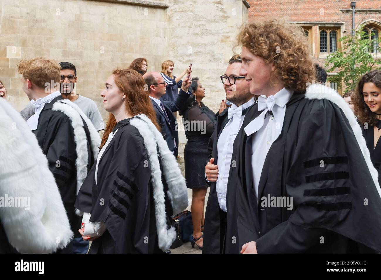 29 6 2022 back view of Male and female fresh graduate students with ...