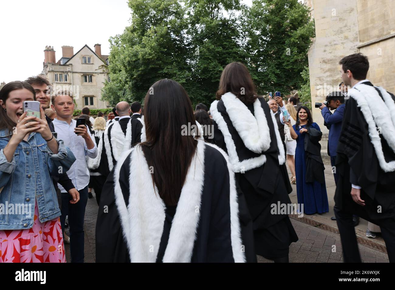 29 6 2022 back view of Male and female fresh graduate students with ...