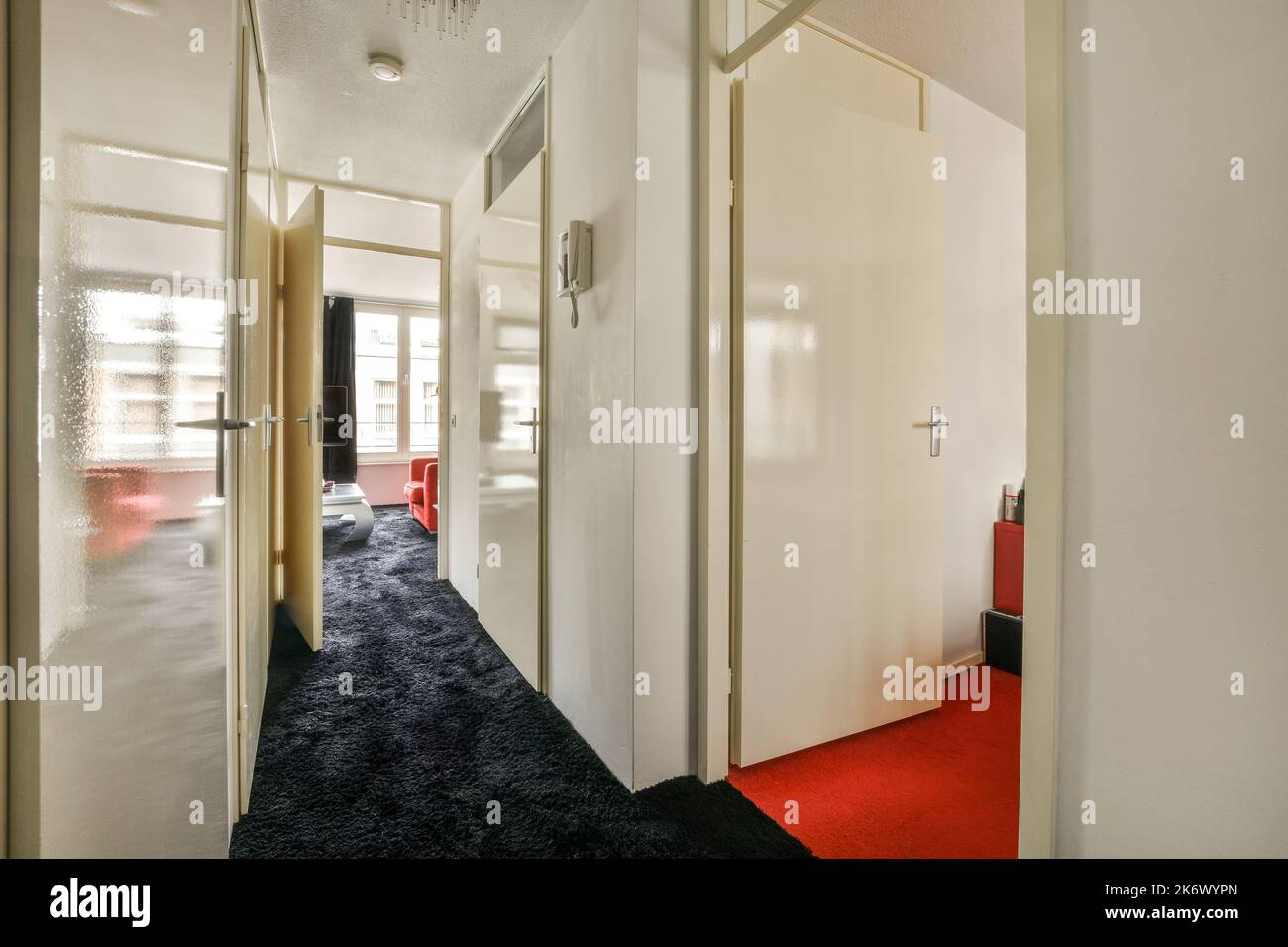 Light narrow hallway with many doors in white walls and glowing lamp Stock Photo - Alamy