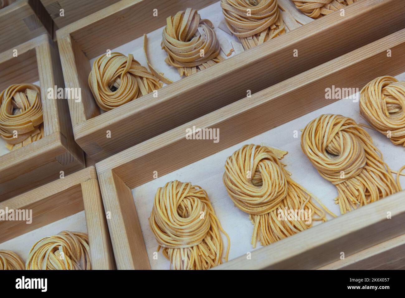 Small packets of fresh pasta in a wooden crate Stock Photo - Alamy