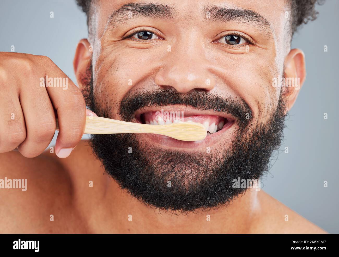 The perfect smile takes work. Studio portrait of a handsome young man ...