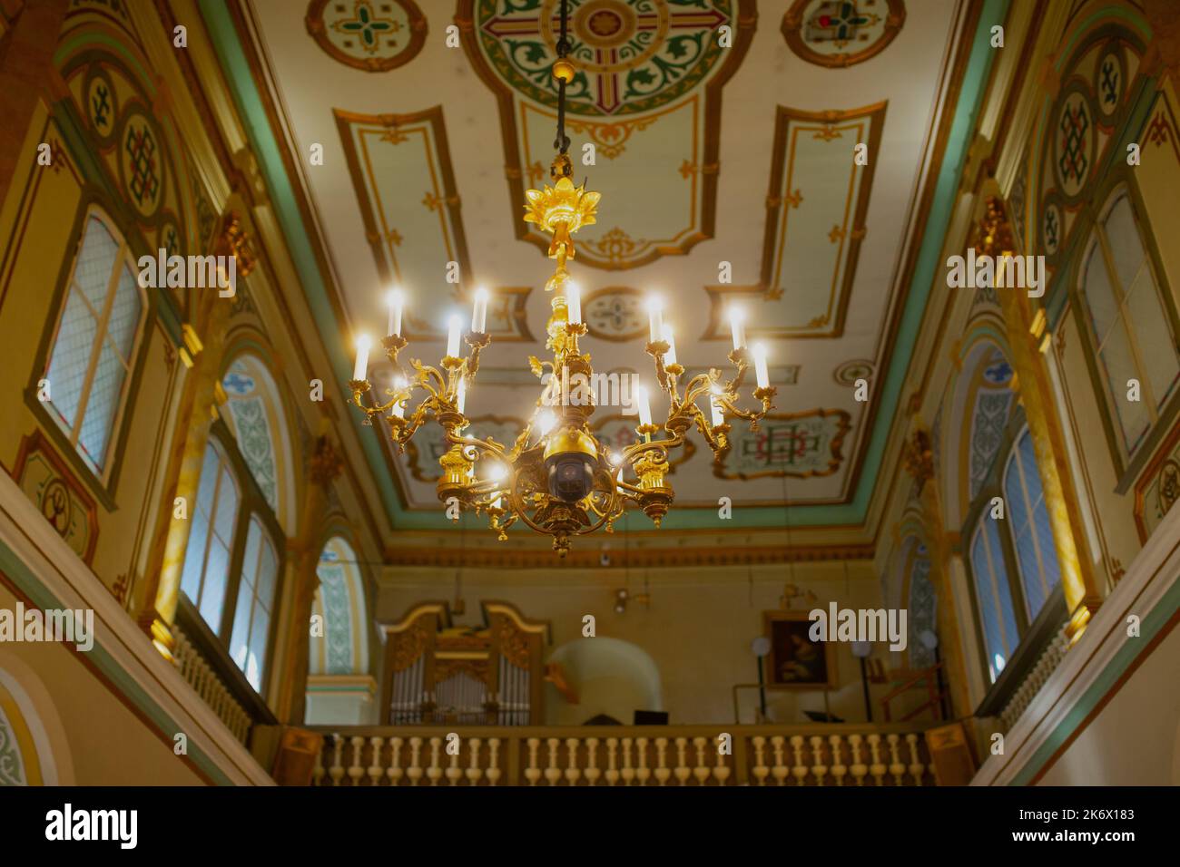 Golden chandelier hangs from the ceiling of a catholic church in Riga ...