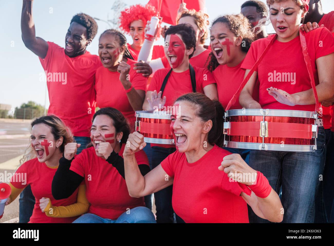 Close-up of a group of very happy and joyful fans supporting their ...