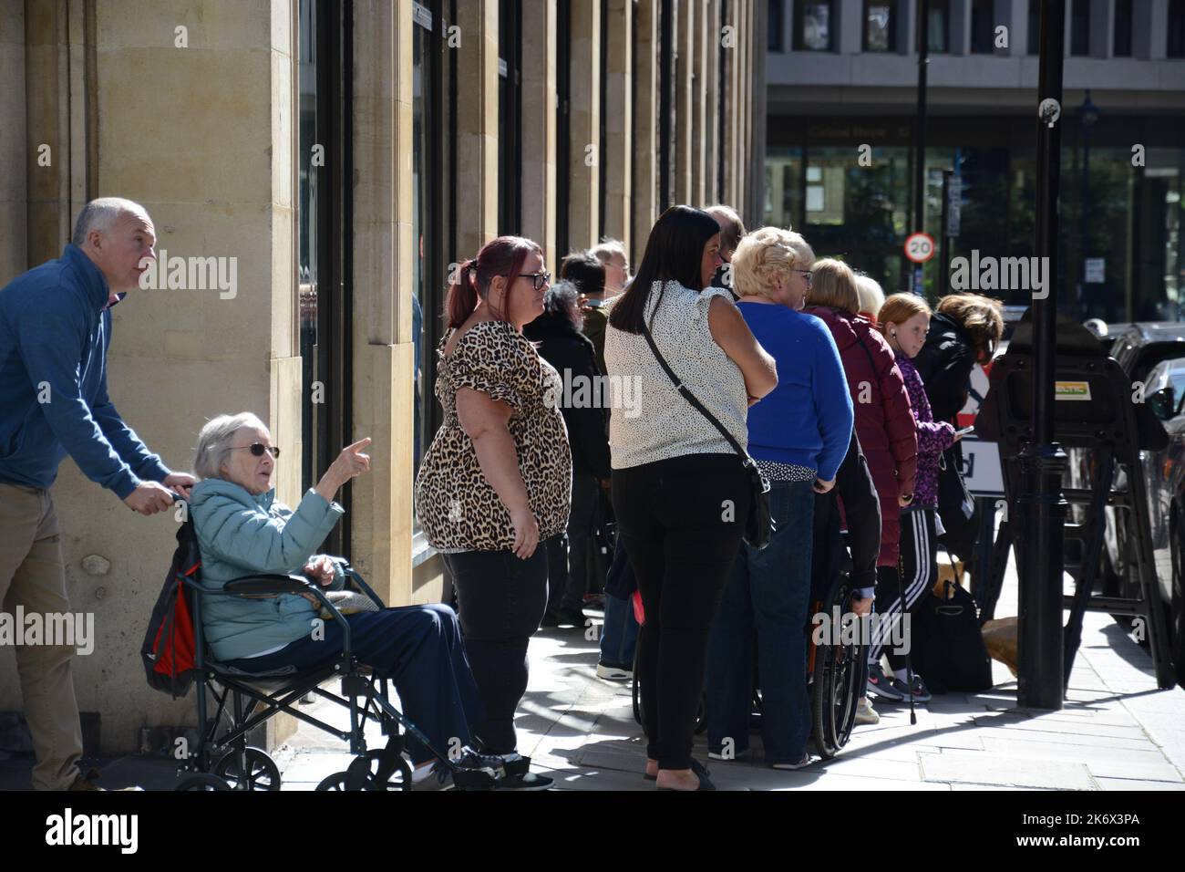 Patient people with accessibility requirements queue to see the coffin ...