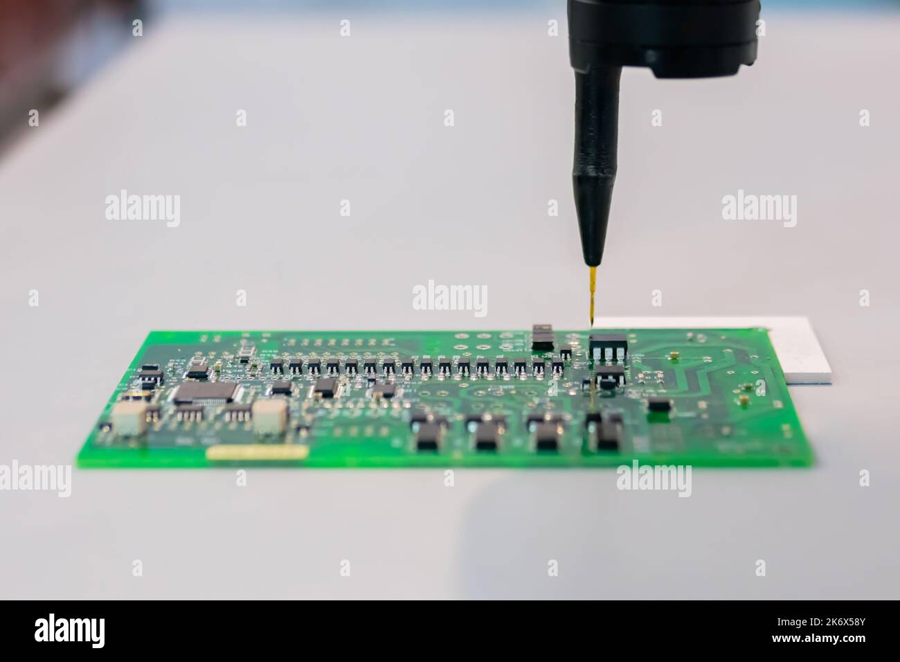 Automatic manipulator with dispenser needle during work with SMT pcb ...