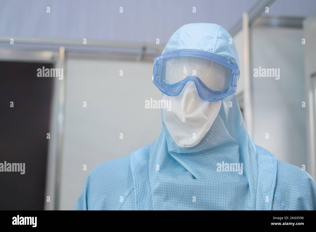 Protective medical clothing with hood and goggles at dummy Stock Photo ...