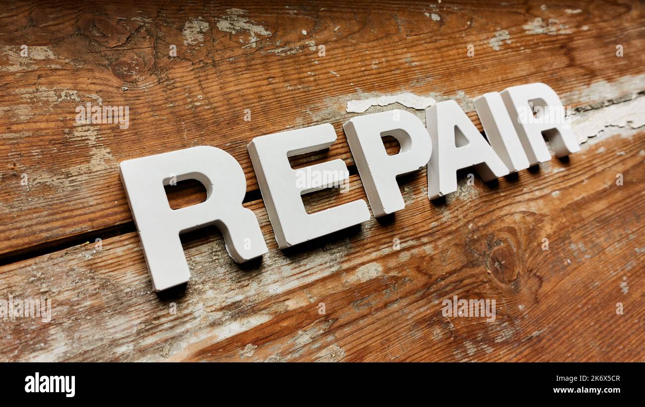 Repair - Text on old shabby wood Stock Photo - Alamy
