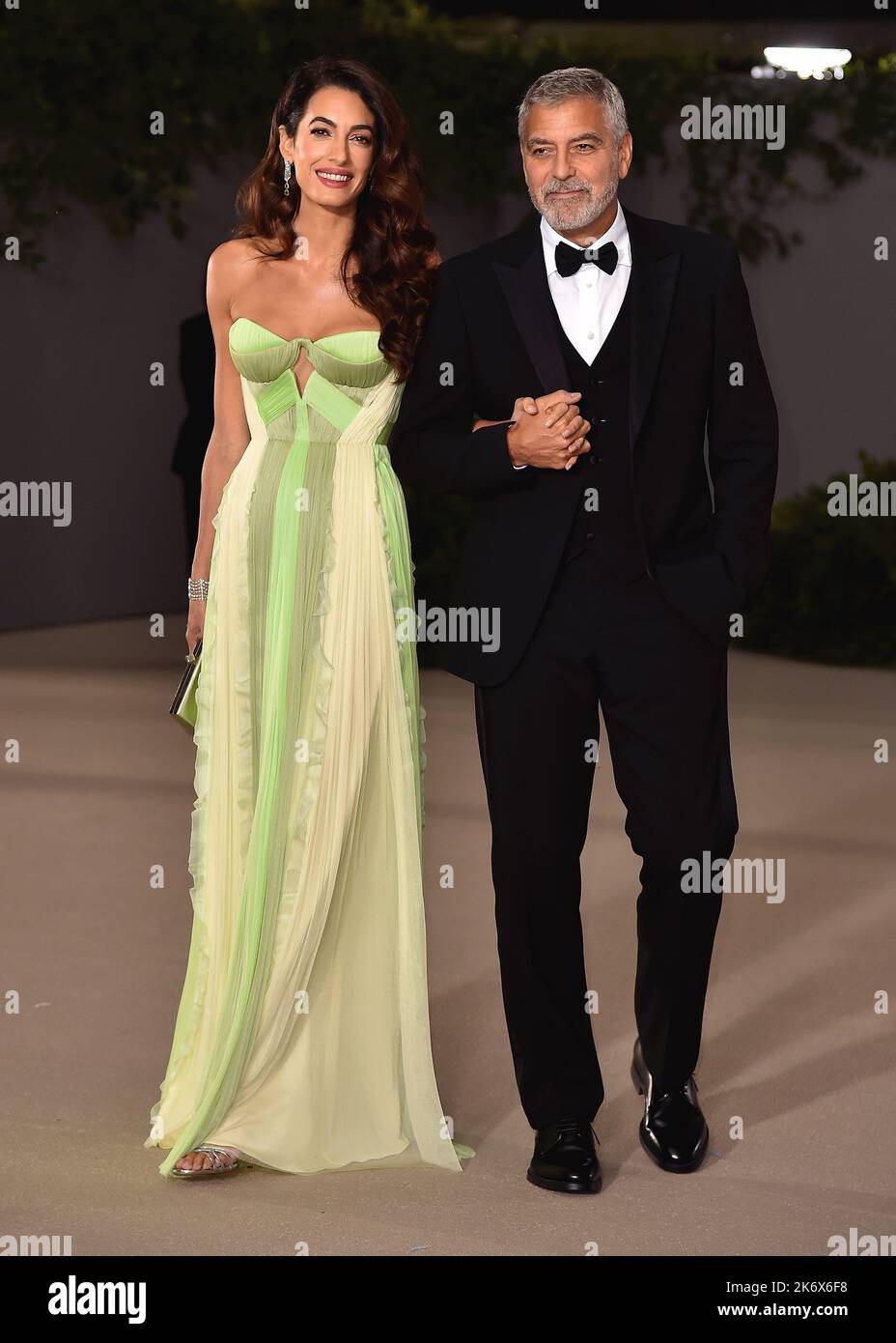 Amal Clooney and George Clooney walking the red carpet at the Second ...
