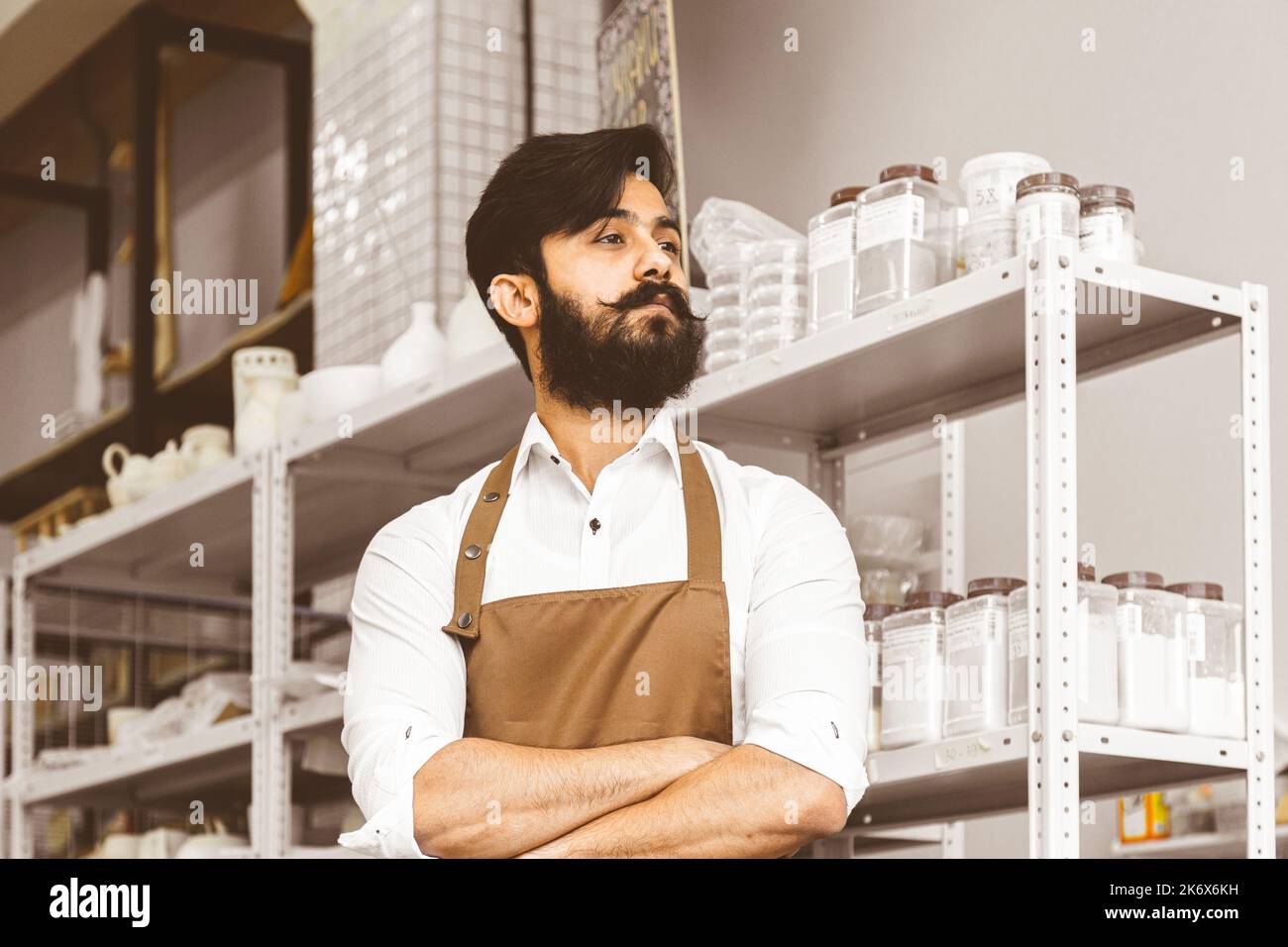 Portrait of a young attractive businessman craftsman with a beard and ...