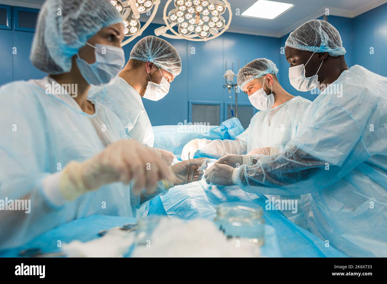 An international team of doctors performs a complex surgical operation ...