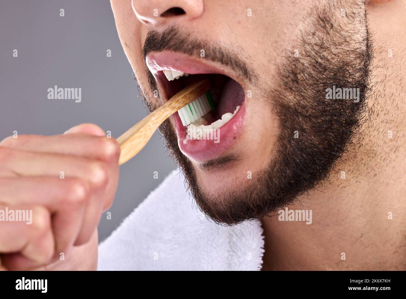 Its not just the front teeth that needs brushing. a young man brushing ...