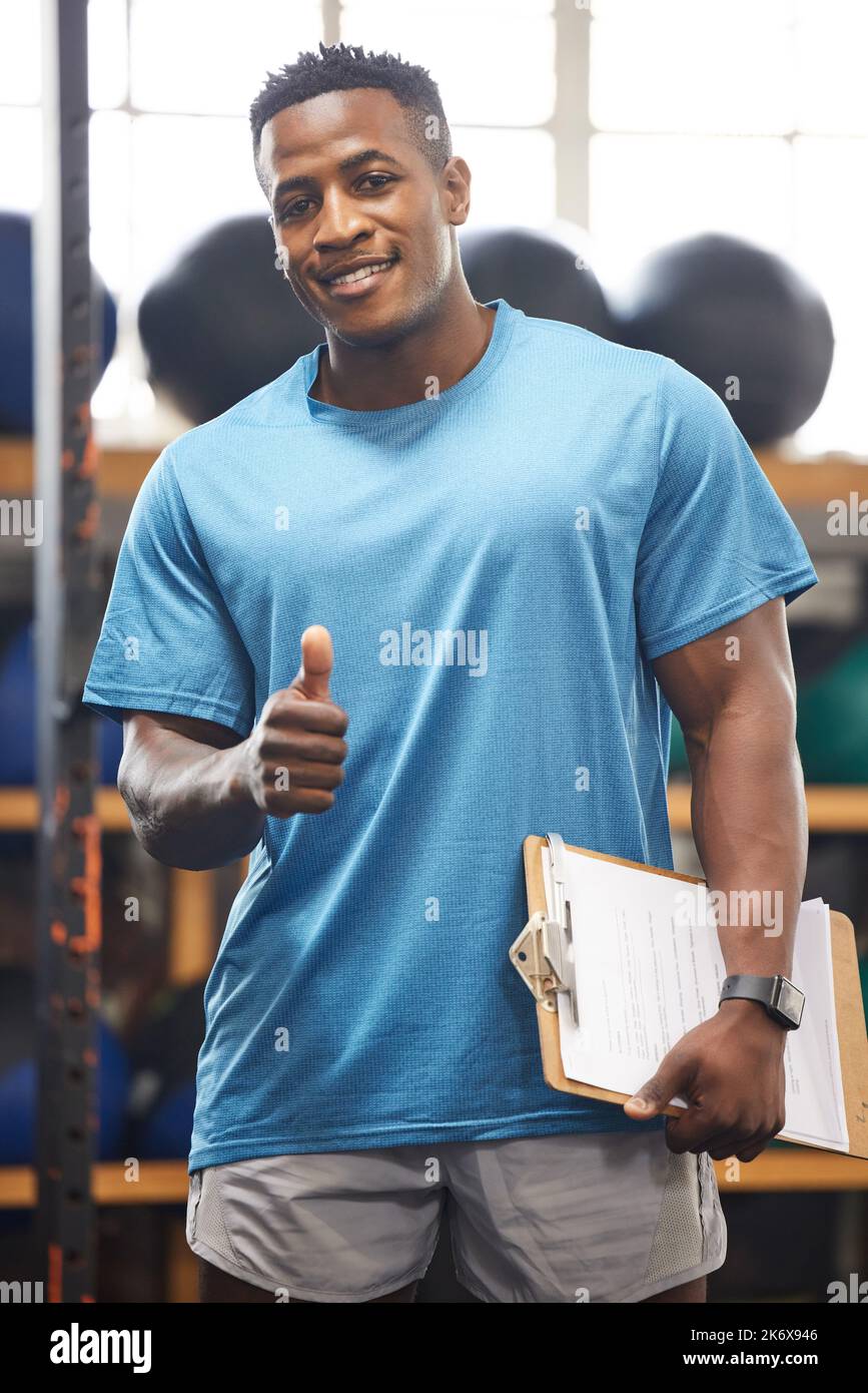 You wont go wrong by joining our gym. Portrait of a muscular young man ...