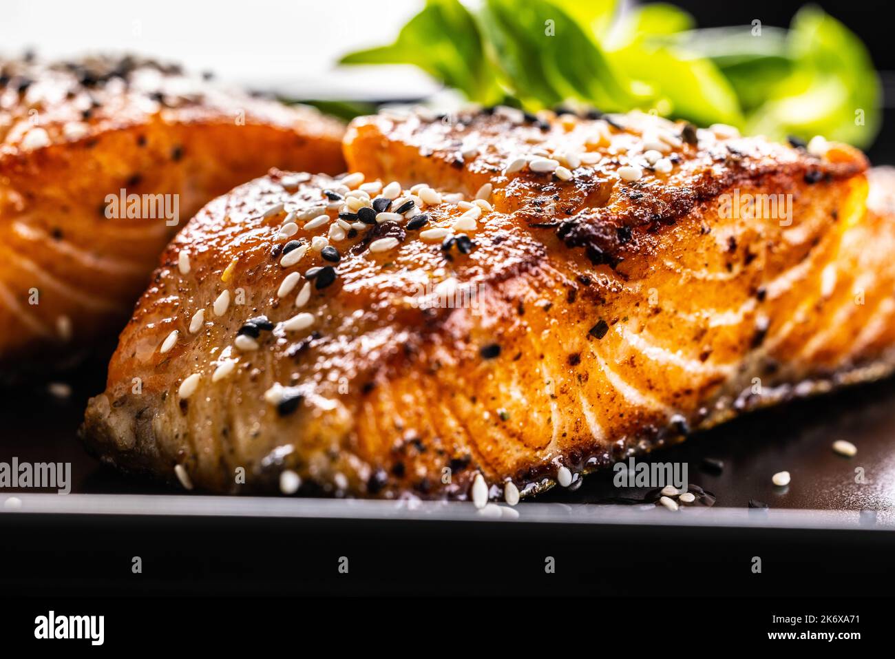 Two salmon fillets baked until crispy with sesame - Close up Stock ...
