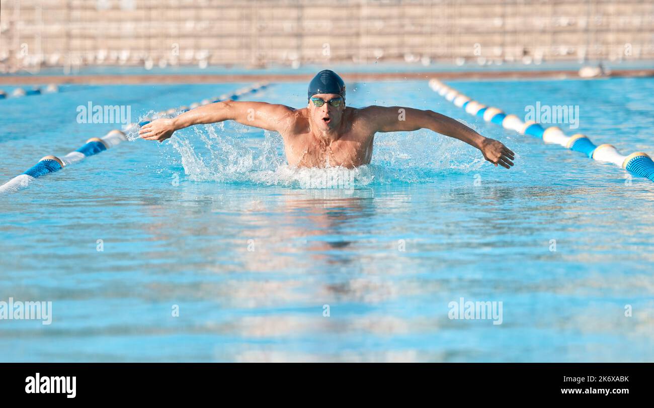 Putting in the laps. a handsome young male athlete swimming in an ...