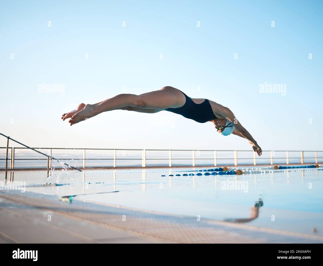 Its a leap of faith. an unrecognizable young female athlete swimming in ...