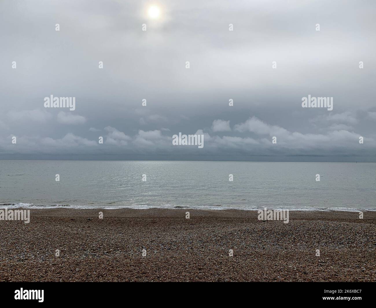 Autumn sky with grey cloud formations seen over the beach on the south ...
