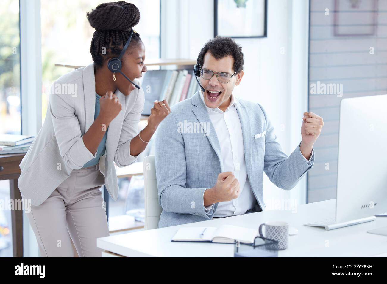 Hell yeah were good at this. two young call centre agents cheering ...