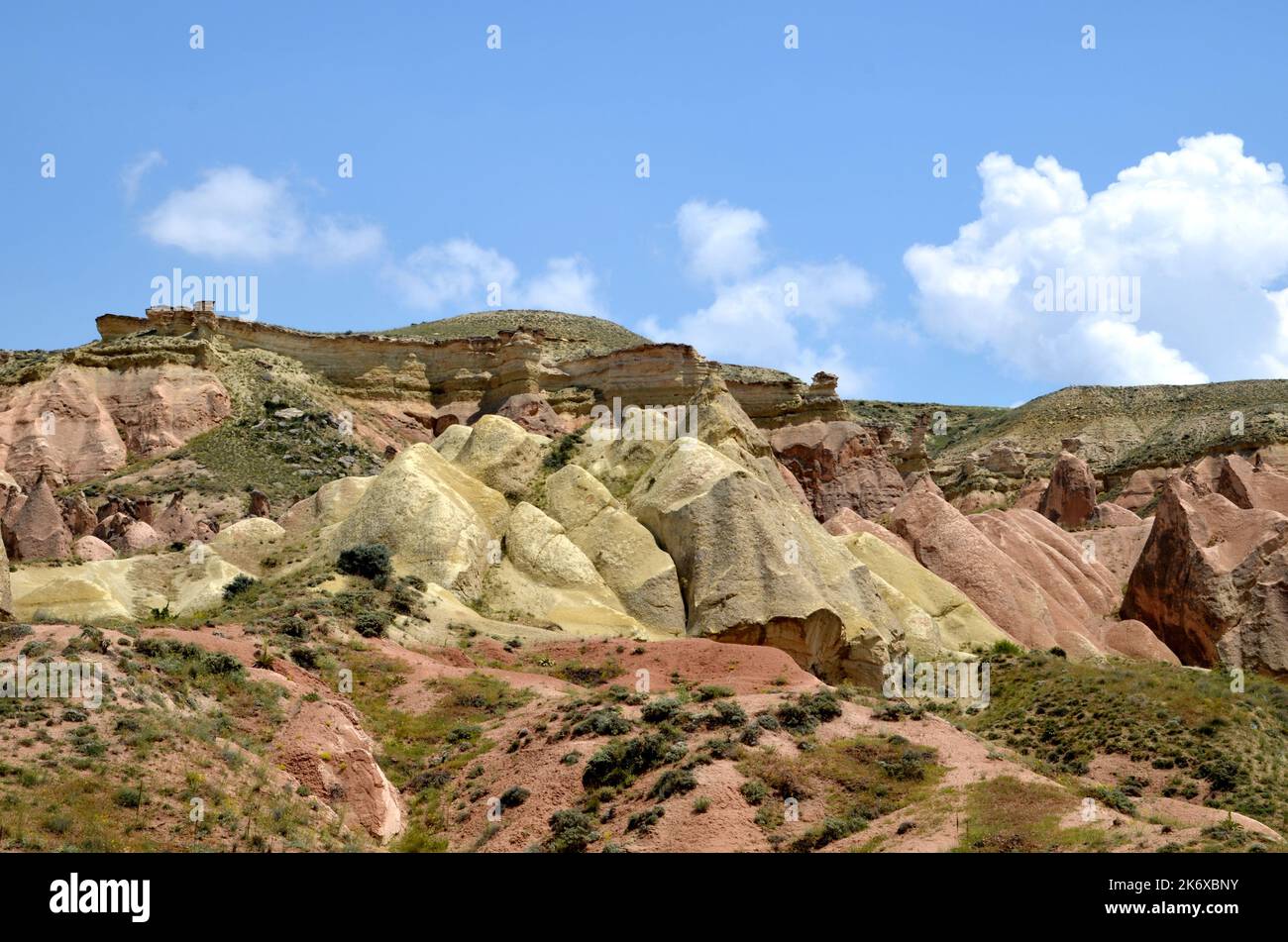 colorful rock formation with plants and meadows in Cappadocia, turkey ...
