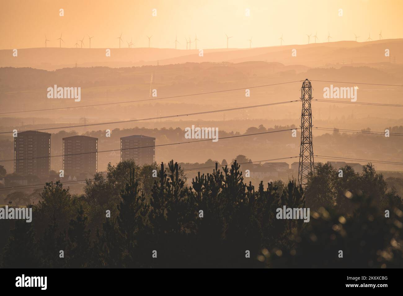 city scape with electricity pylon sunset over outerglasgow, clydebank ...