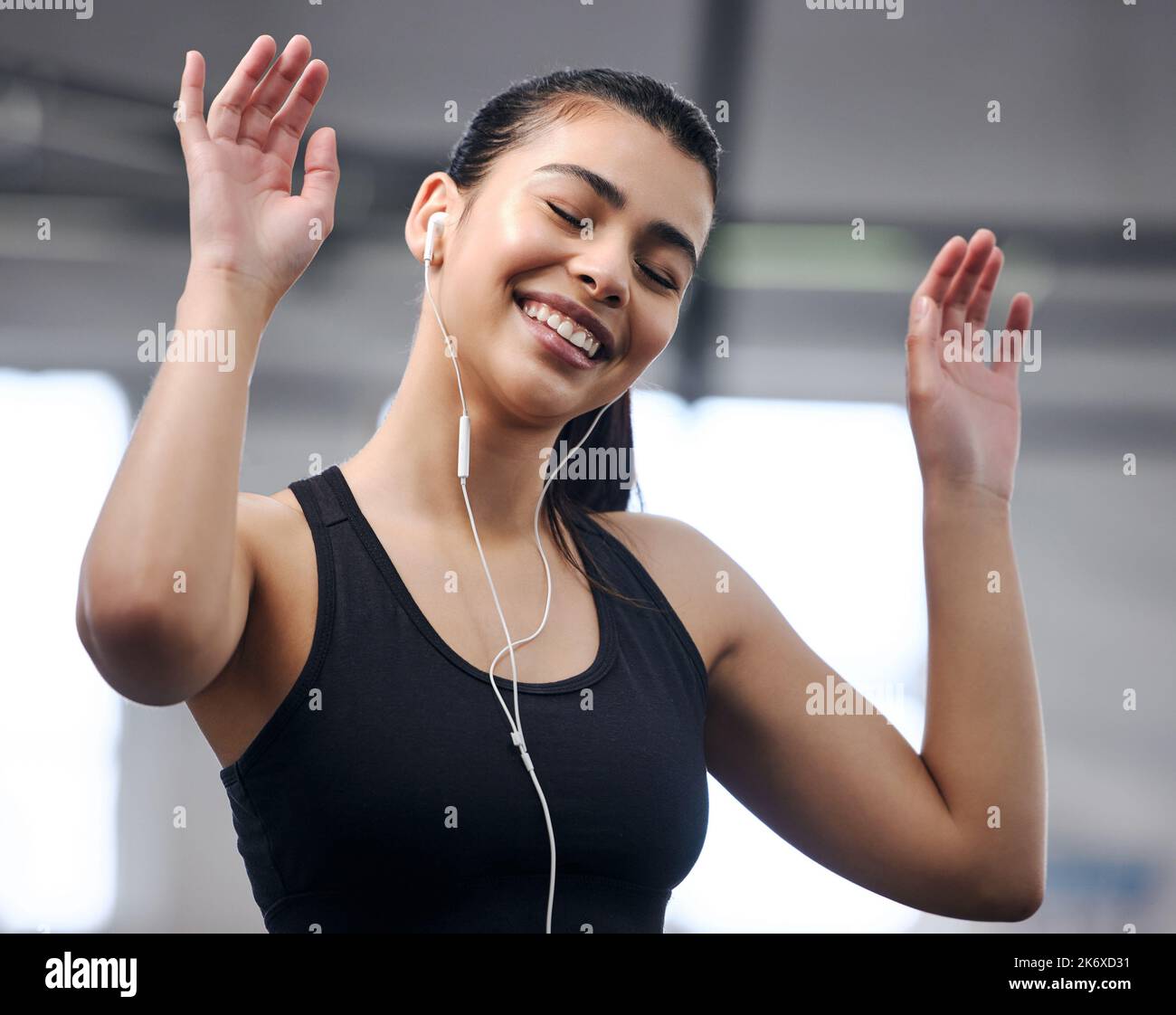 Pumped up music for a pumped up workout. a fit young woman using ...