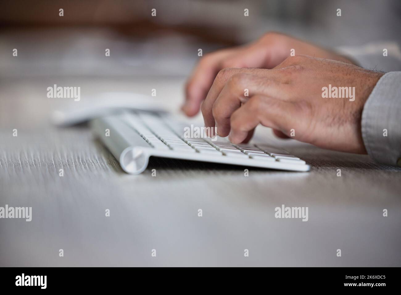 Typing in a clients details. an unrecognisable businessman typing on ...