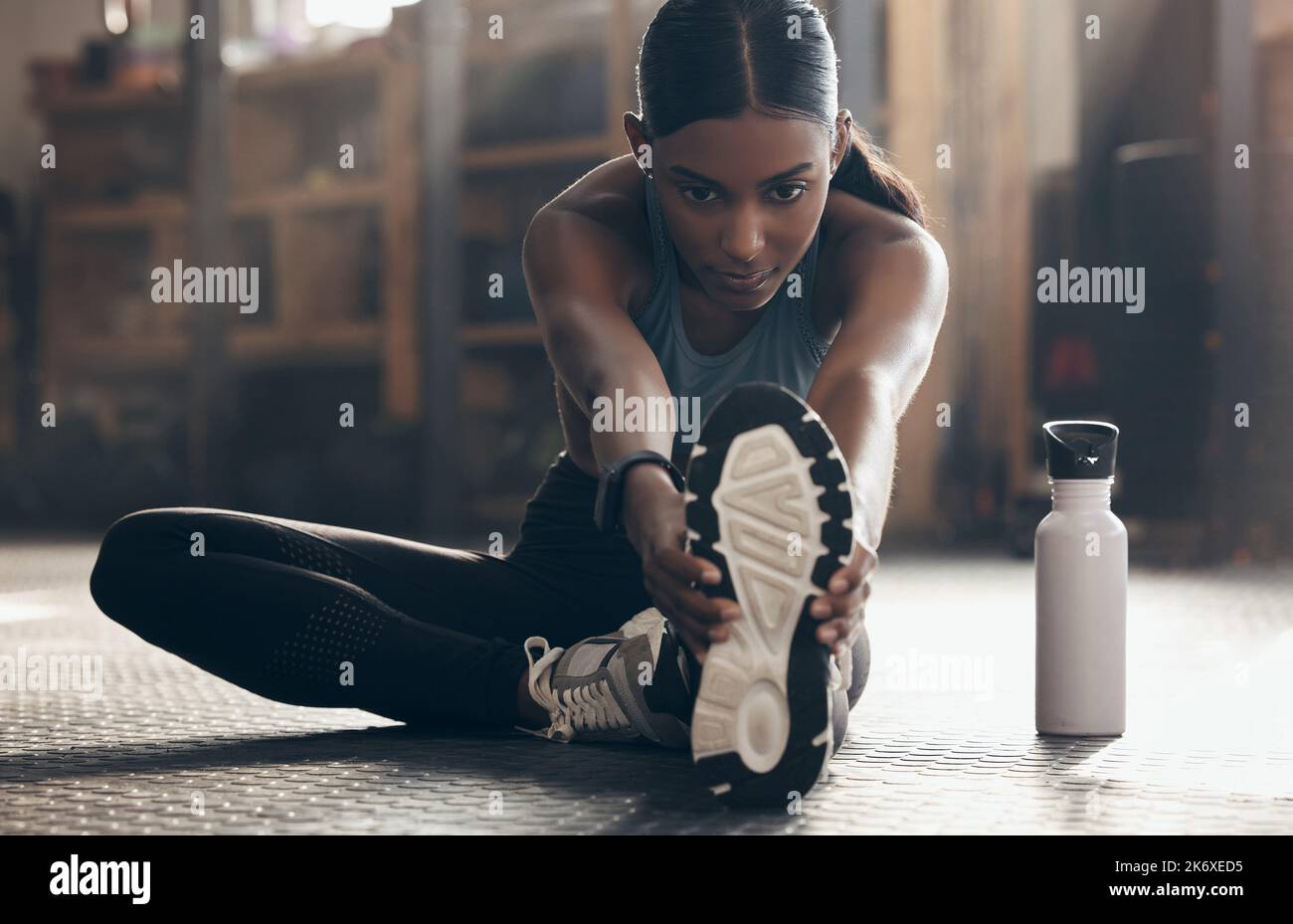 Getting limber and flexible before starting her session. a sporty young ...