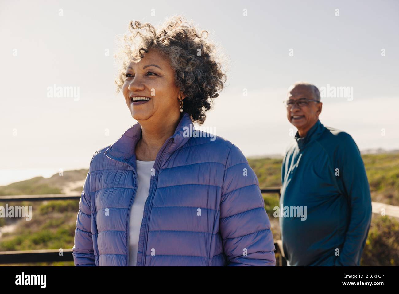 Happy senior woman looking at a refreshing view while standing on a ...