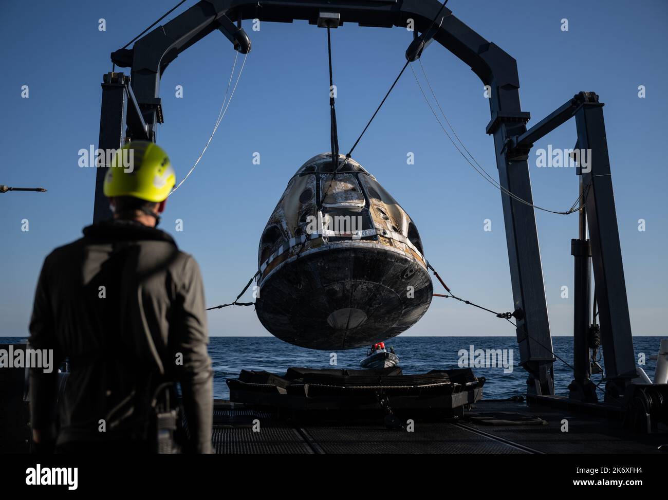 Support teams raise the SpaceX Crew Dragon Freedom spacecraft aboard ...