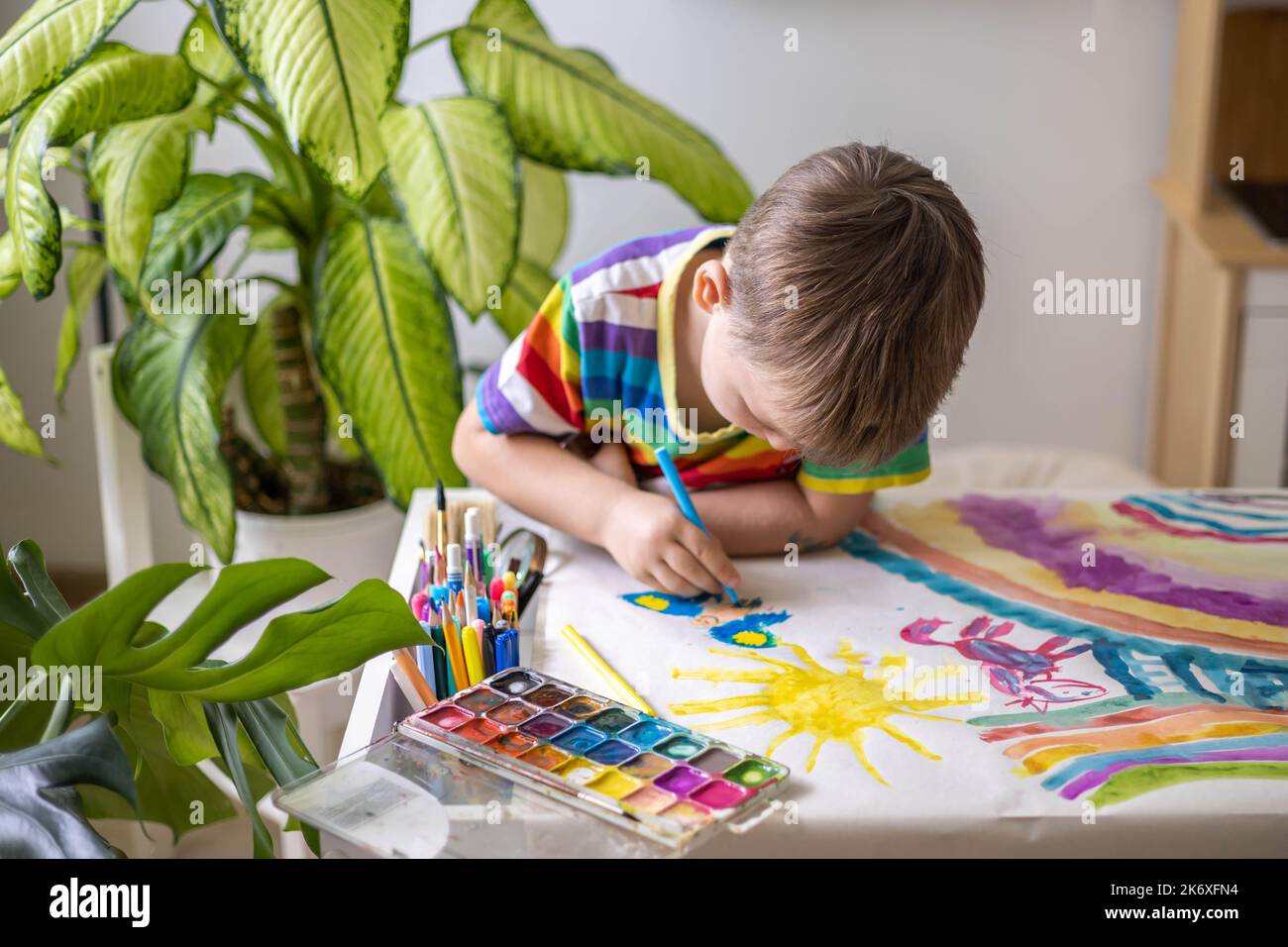 Confident cute male kid art drawing multicolored rainbow arch use ...