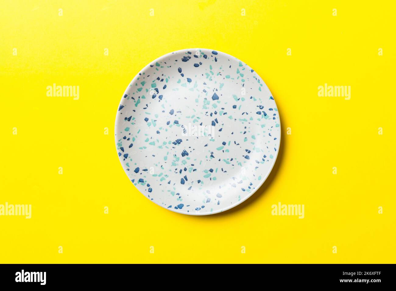 Top view of isolated of colored background empty round blue plate for ...