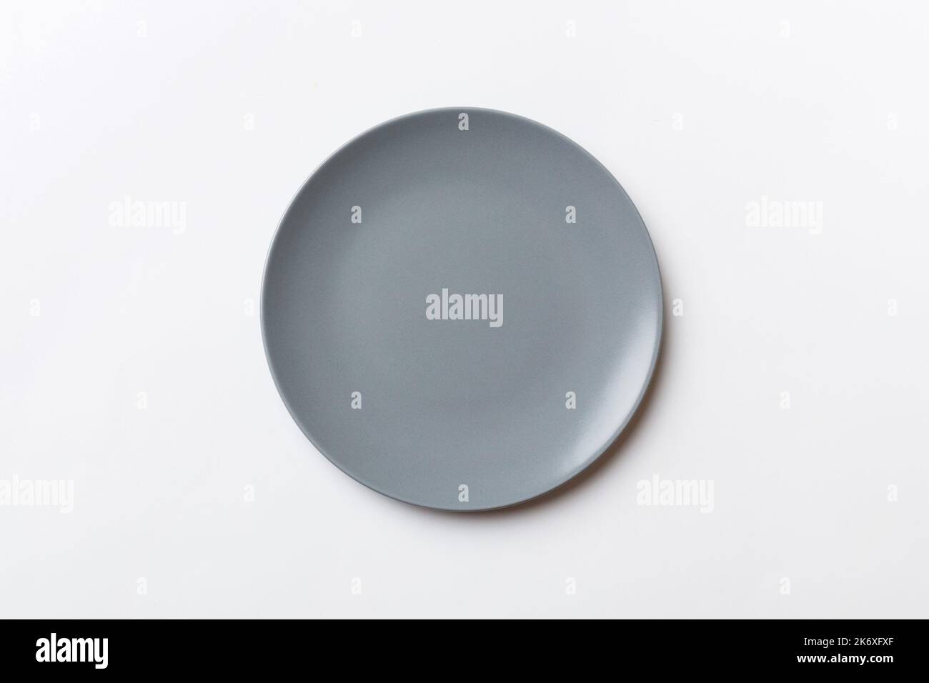 Top view of isolated of colored background empty round gray plate for ...