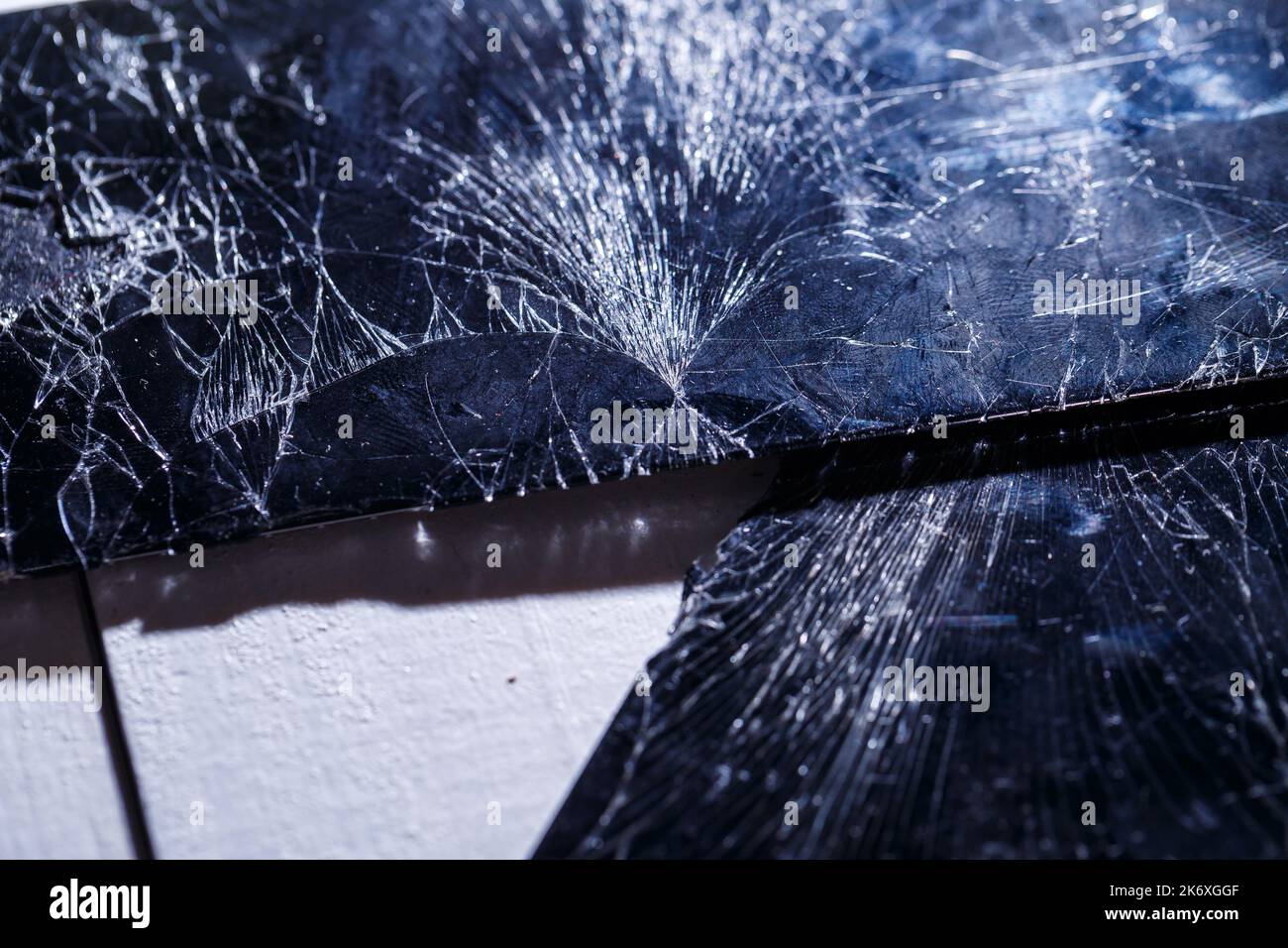 Mobile tablet device with a broken badly cracked shattered glass on the ...