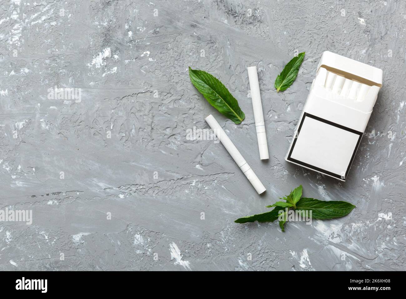 Pack of menthol cigarettes and fresh mint on colored table, Menthol ...