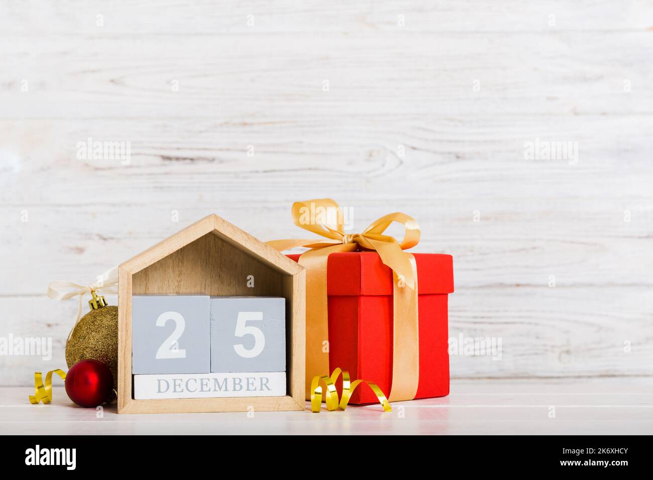25 december. Christmas composition on colored background with a wooden ...
