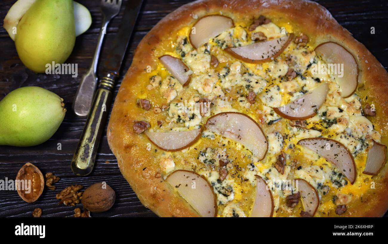 Homemade pizza with pear and walnuts. Dorblu pizza Stock Photo - Alamy