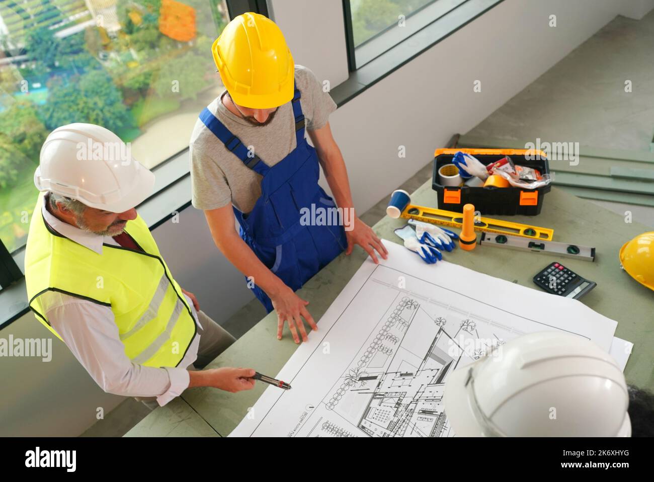 Architect and construction engineer or surveyor discussion plans and ...